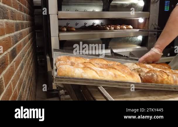 Craft mini-bakery producing French pastries. The baker takes freshly ...