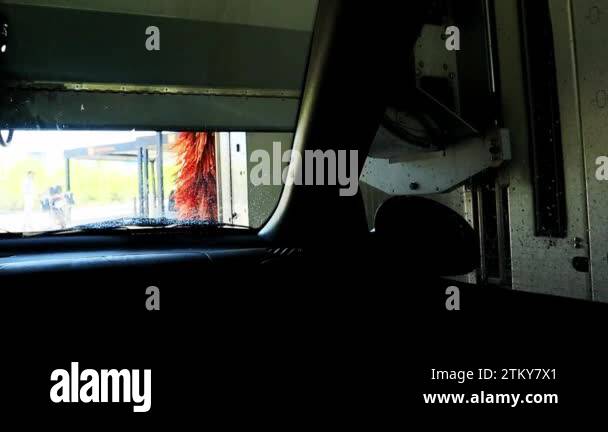 Washing the car in an automatic wash. View of the automobile from ...