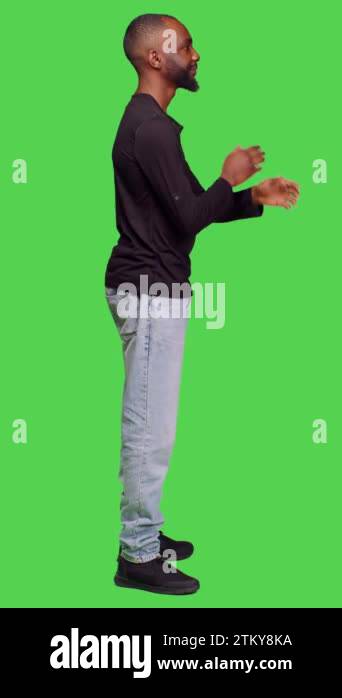 Vertical video: Profile of friendly casual person posing over full body ...