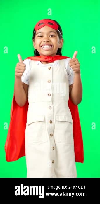 Little girl, superhero and thumbs up on green screen for success ...