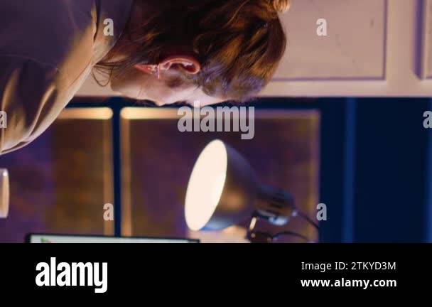 Vertical video: Office worker looking at computer running diagrams on ...