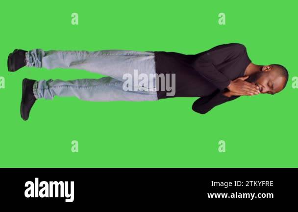 Vertical video: Side view of young adult feeling tired and yawning on ...