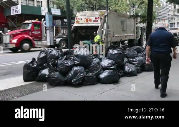 Garbage Truck in NYC and two DSNY workers Loading Black Garbage Trash ...