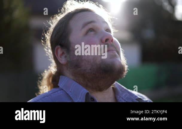 Happy contemplative young man opening eyes to sky with HOPE and FAITH ...