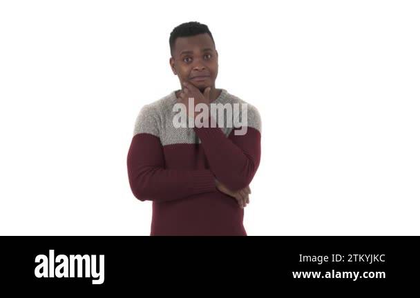 Man nods his head slightly while touching his chin and then looks at ...