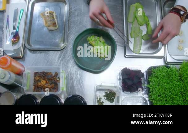 Chef makes dish composition for serving. The cook puts cooked zucchini ...