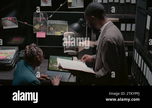 Law agents team analyzing private records in evidence room, conducting ...