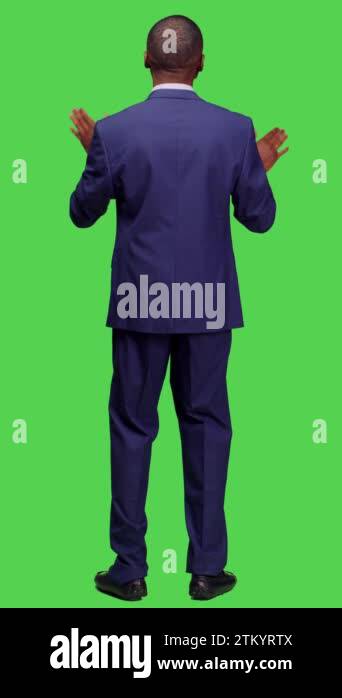 Vertical video: Back view of smiling entrepreneur in suit applauding on ...