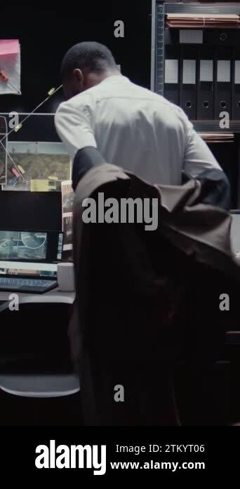 Vertical video: Law enforcement agent doing detective work in office ...