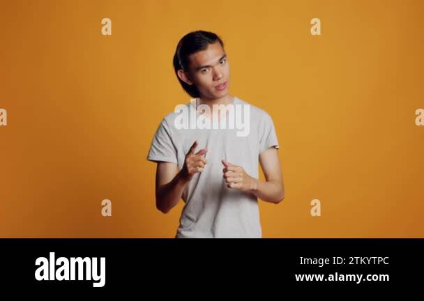 Asian man clenching fists and acting violent, causing conflict and ...