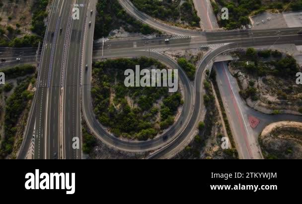 Top down view of road junction with moving cars. Road interchange or ...