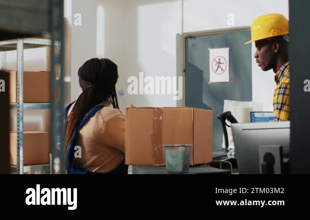 Team of young people working on depot logistics and packing goods ...