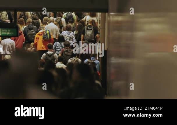 A crowd passengers walking to the exit in metro undeground, close up ...