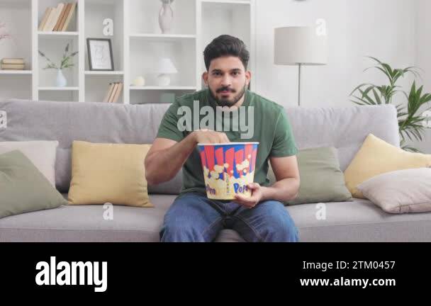 Handsome bearded guy of indian nationality sitting on cozy sofa. Young ...