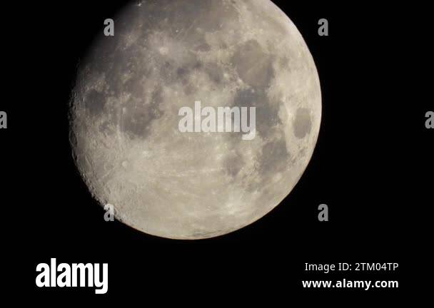 Moon moves in the frame close-up. View through a telescope. Meteor craters on the surface of the ...