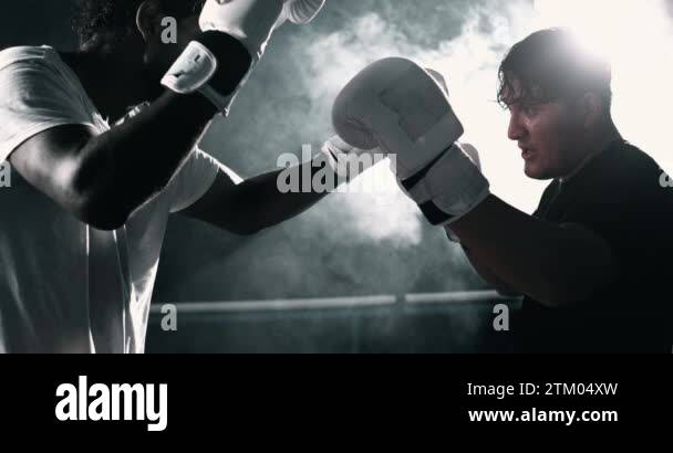 Two fighters face to face during boxing match inside ring with dramatic ...