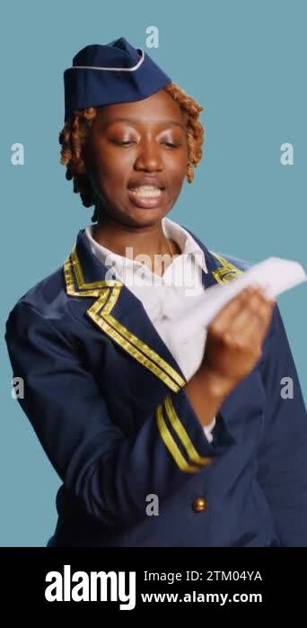 Vertical video: Cheerful silly stewardess playing with paper plane ...