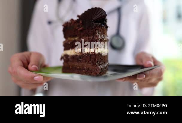 Nutritionist holds sweet chocolate cake and warns about dangers of ...