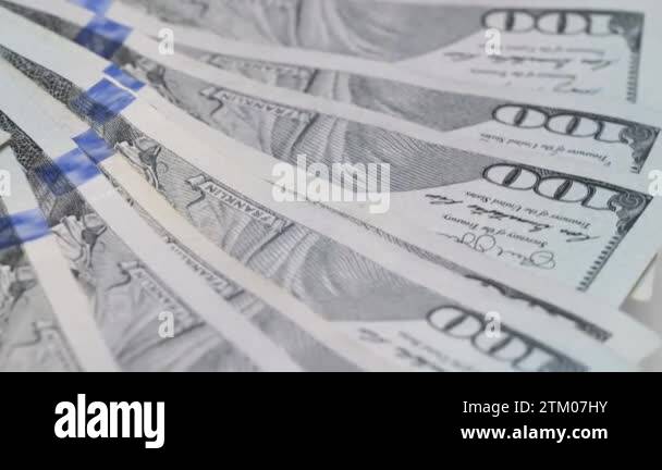 Rotation background of a pile of US currency bills spinning on a table ...