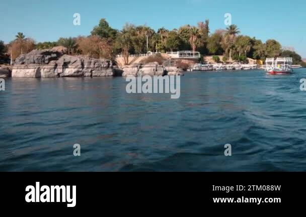 Nile river in Aswan, Egypt afternoon shot showing feluccas and boats in ...