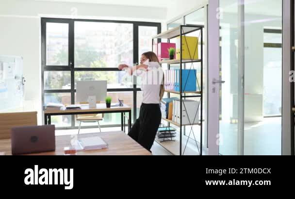 Happy joyful young and attractive woman dancing victory dance in office ...