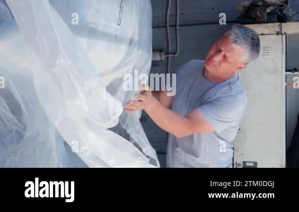 An auto repair shop worker seals all cavities and visible paint ...