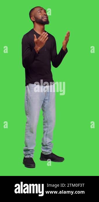 Vertical video: Side view of young spiritual man praying to jesus in ...