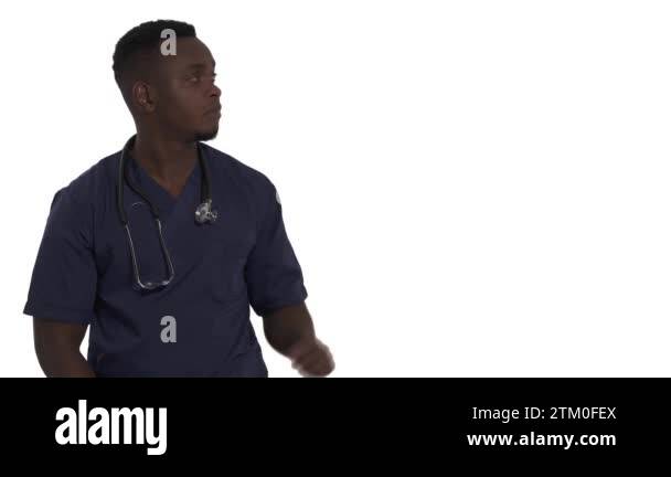 Close-up of a serious young doctor wearing stethoscope around his neck ...