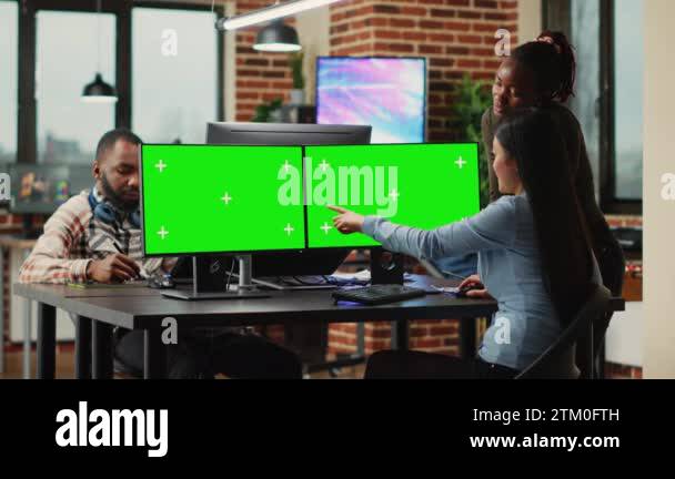 Team Of Diverse Workers Analyzing Computers With Greenscreen Template