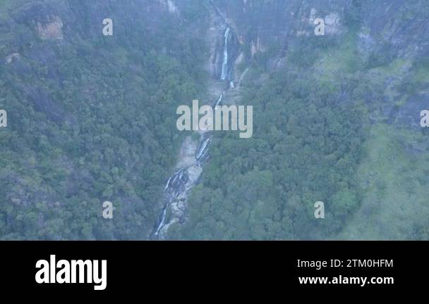 Ravana Falls flows in giant forestry mountains of Sri Lanka. Waterfall ...