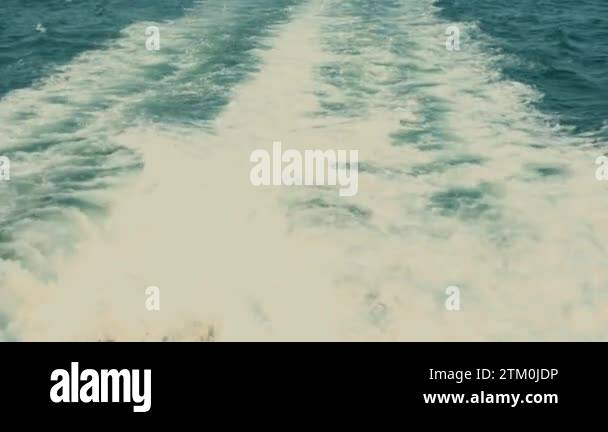 Ship following seagulls flying over the sparkling path behind the stern ...