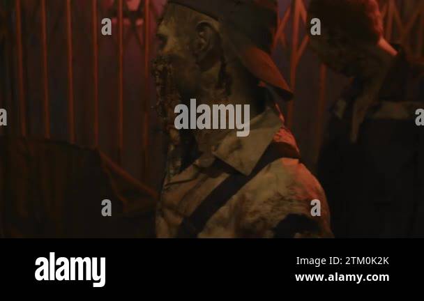 Military woman with shaved head standing in dark creepy building ...