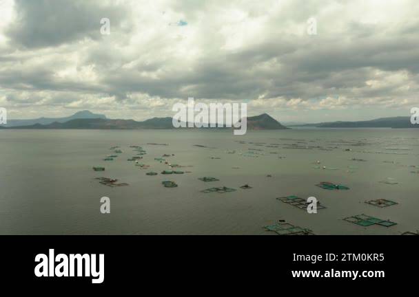 Lake Taal with a volcano and fish cages on a fish farm view from above ...