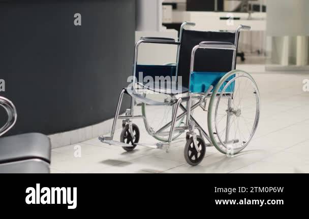 Wheelchair placed in hospital lobby area, hospital reception counter ...
