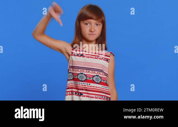 Dislike. Upset young preteen child girl kid showing thumbs down sign ...