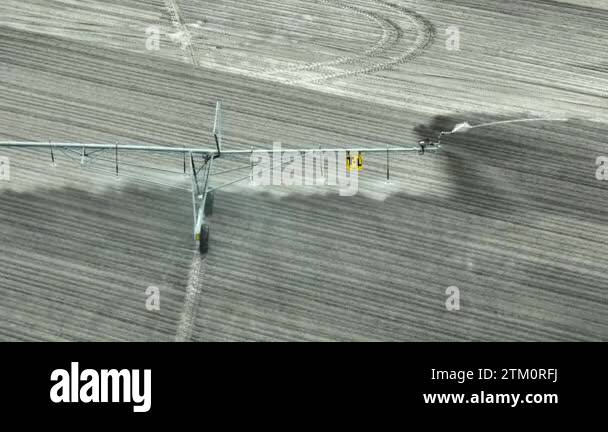 Aerial view of irrigation system watering farm field during dry season ...
