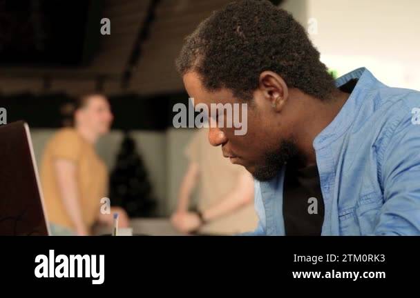 Black Man Writing Lines of Code On Desktop PC With Two Monitors and a ...