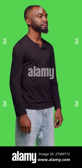 Vertical video: Side view of young male model feeling stylish posing on ...