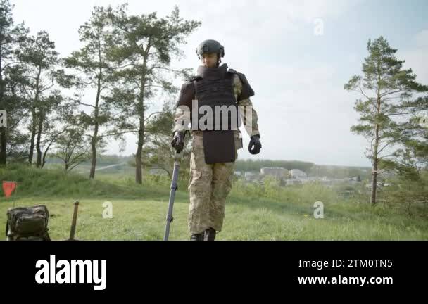 Mine clearance. Military service. Soldier using mine detector ...