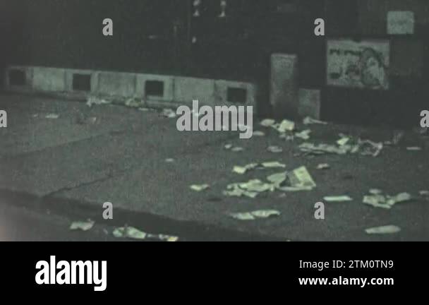 Pieces of paper thrown on a sidewalk on the street in Chicago slum area ...