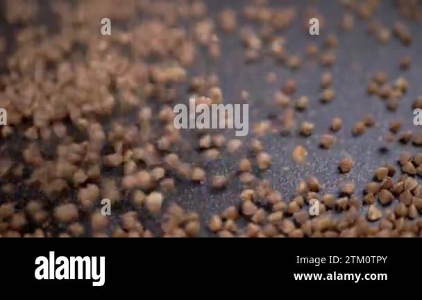 Grains of Buckwheat Fall on a Black Background in Slow Motion. Close up ...