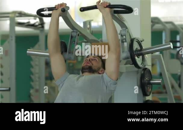 Young man doing exercise for the chest muscles. Slide doing exercise ...