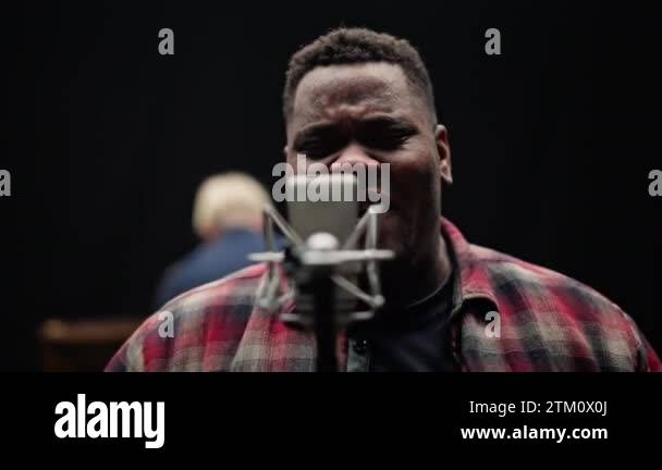 Close-up shot showing the facial expressions of a man while singing an ...