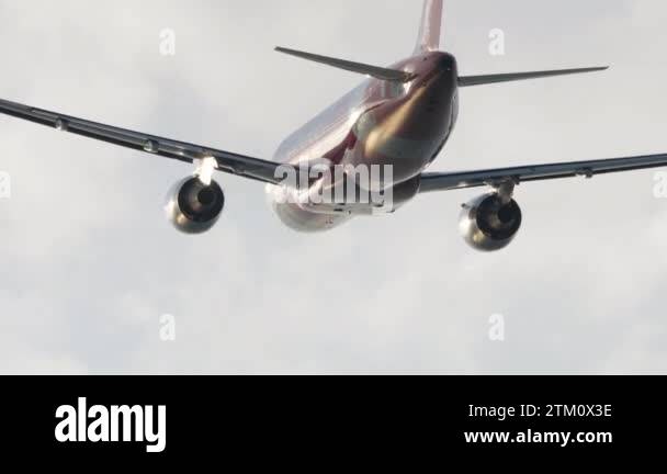 Jet airplane climbing after takeoff. Airliner departure, rear view ...