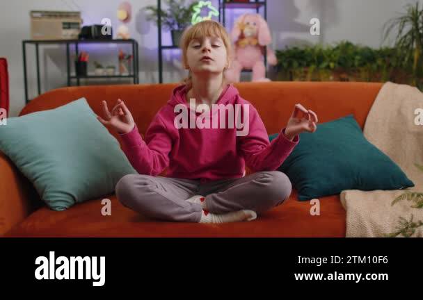 Keep calm down, relax. Young child kid girl breathes deeply with mudra ...