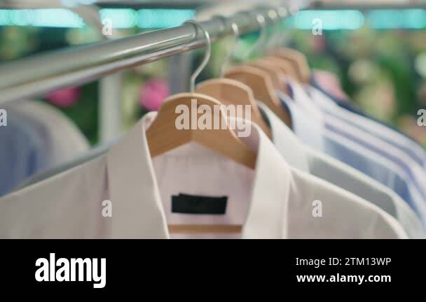 Extreme close up shot of elegant assortment of shirts on hangers in ...