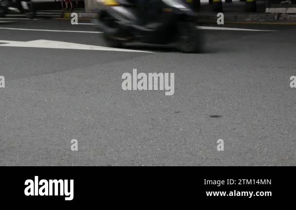 low angle view to the asphalt street road with traffic of many cars and ...