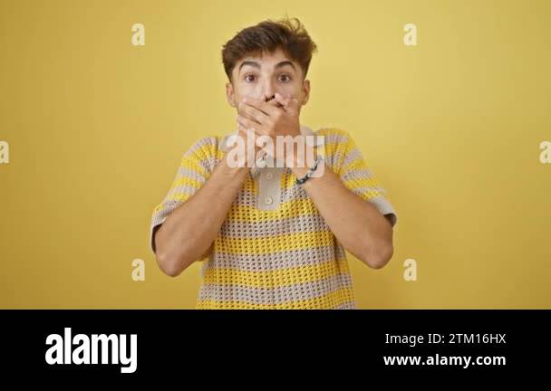 Oh, wow! surprised young arab man, covering his mouth with hands ...
