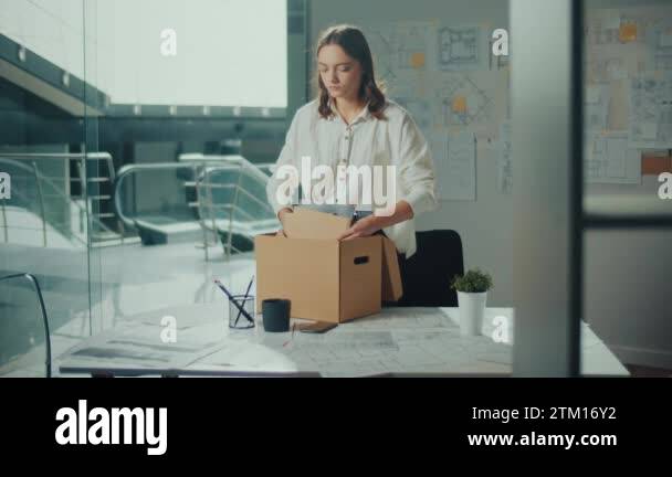 The Woman Was Fired, and She is Packing Things in A Box. Businesswoman ...