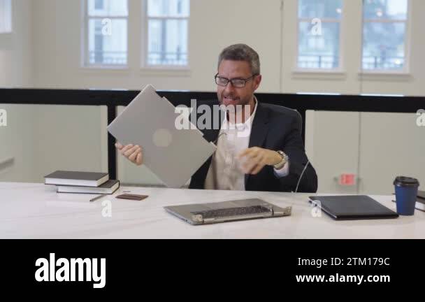 Angry boss broken laptop in office. Businessman broken laptop. Angry ...